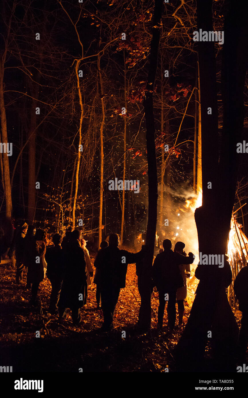 Group of People Standing Around Bonfire at Night Stock Photo - Alamy
