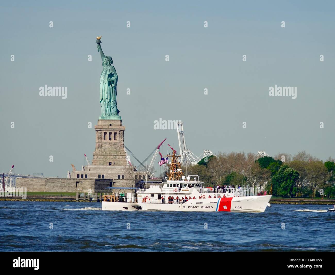 US Coast Guard Sentinel-class cutter sailing in front of the Statue of ...