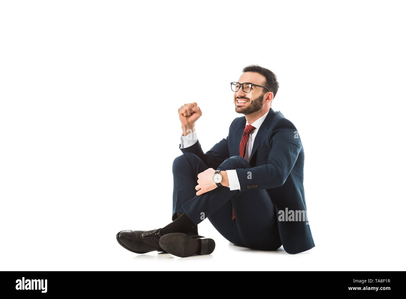 cheerful businessman showing yes gesture while sitting on white ...
