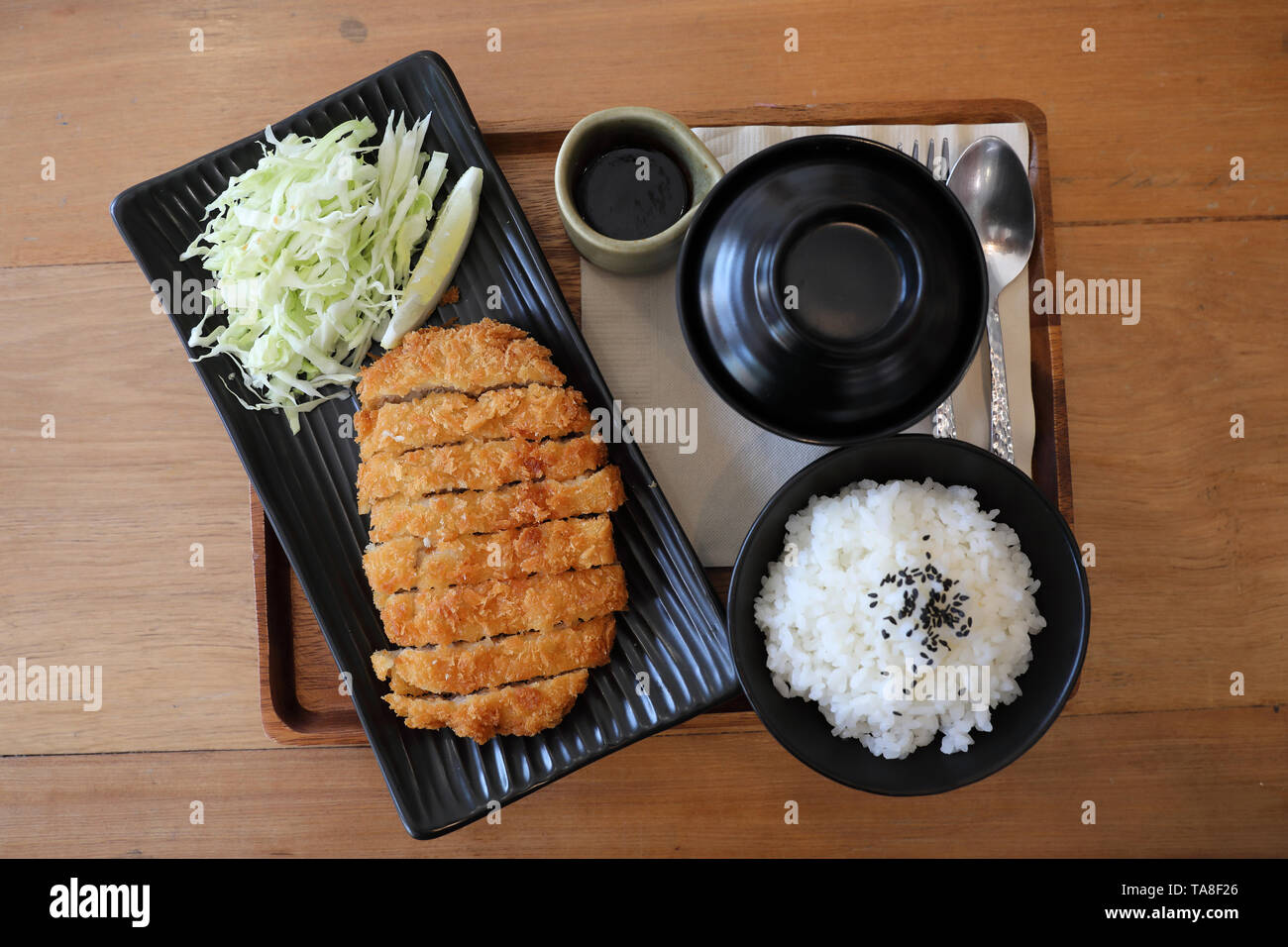 Tonkatsu fried pork cutlet with rice and soup on wooden table Japanese ...