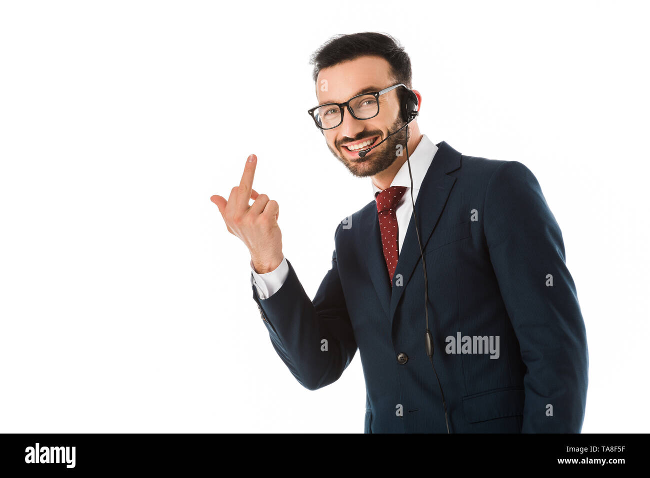 cheerful handsome call center operator in headset showing middle finger ...