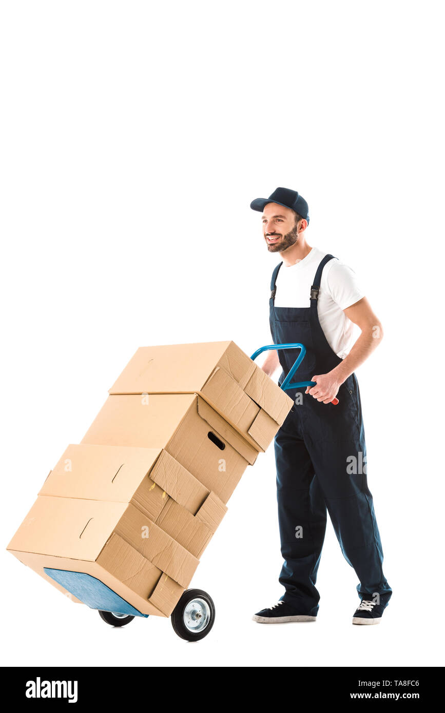 cheerful handsome delivery man transporting cardboard boxes loaded on ...