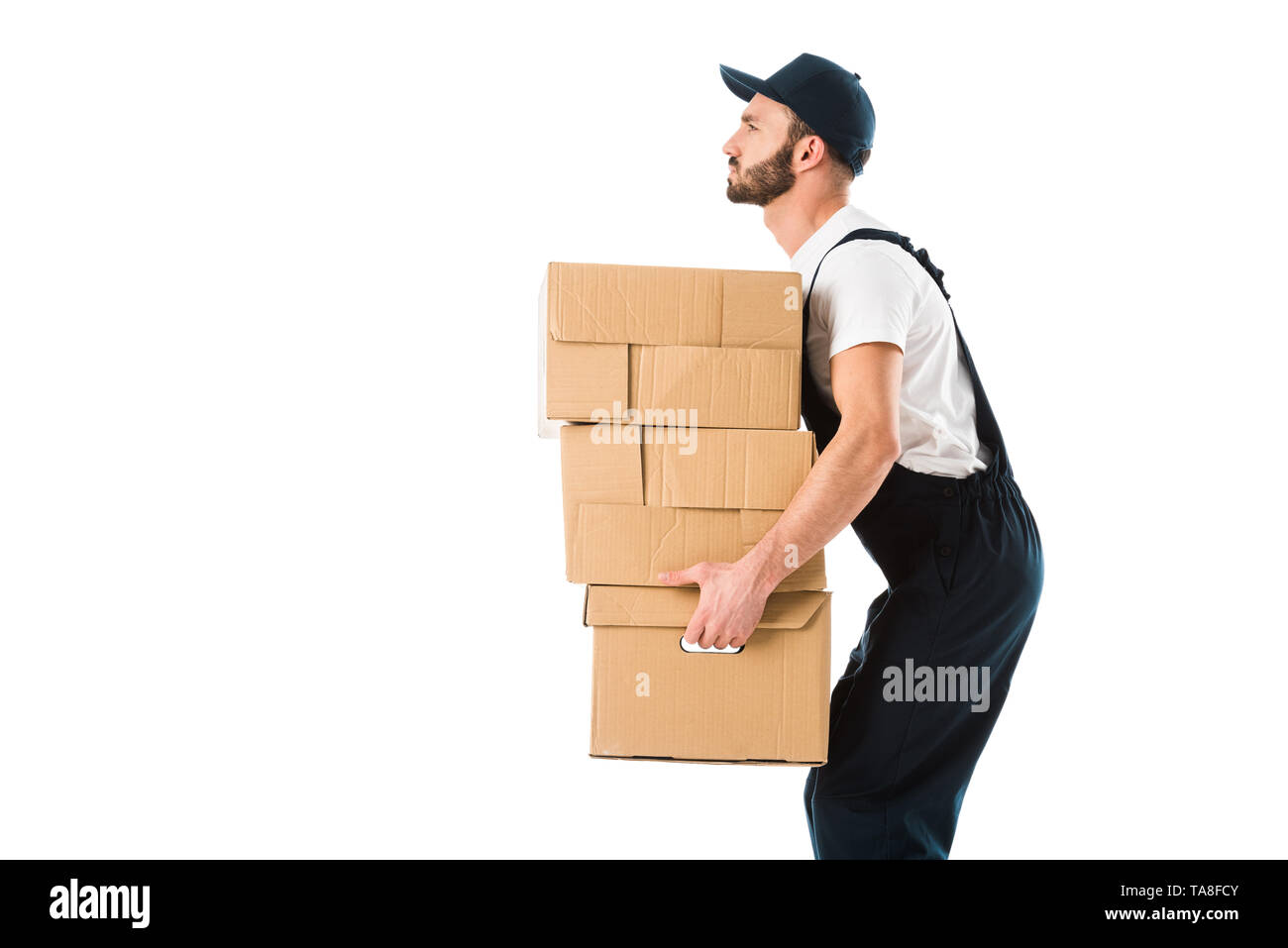 side view of serious delivery man carrying cardboard boxes isolated on ...