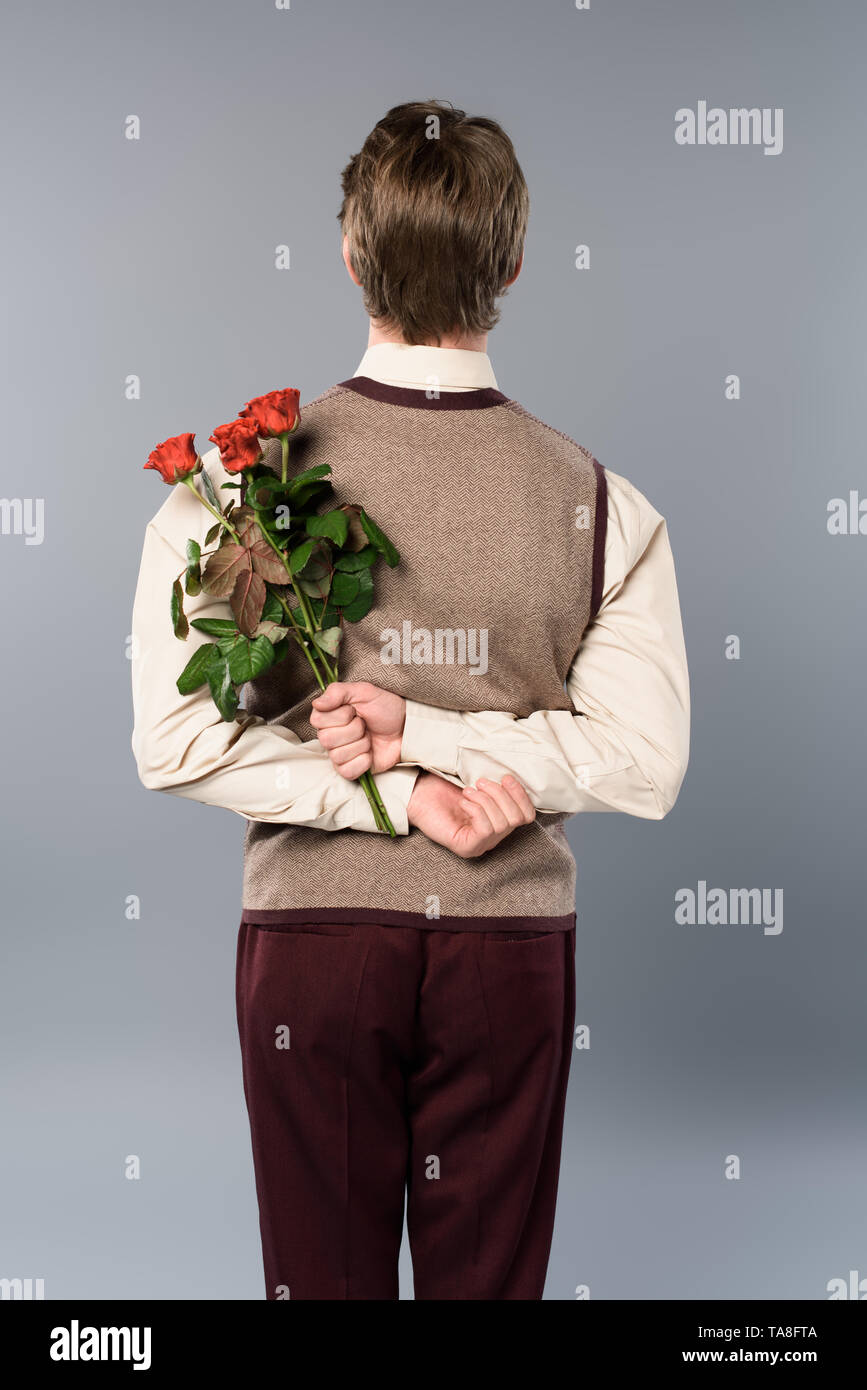 back view of man holding bouquet of roses behind back Stock Photo - Alamy