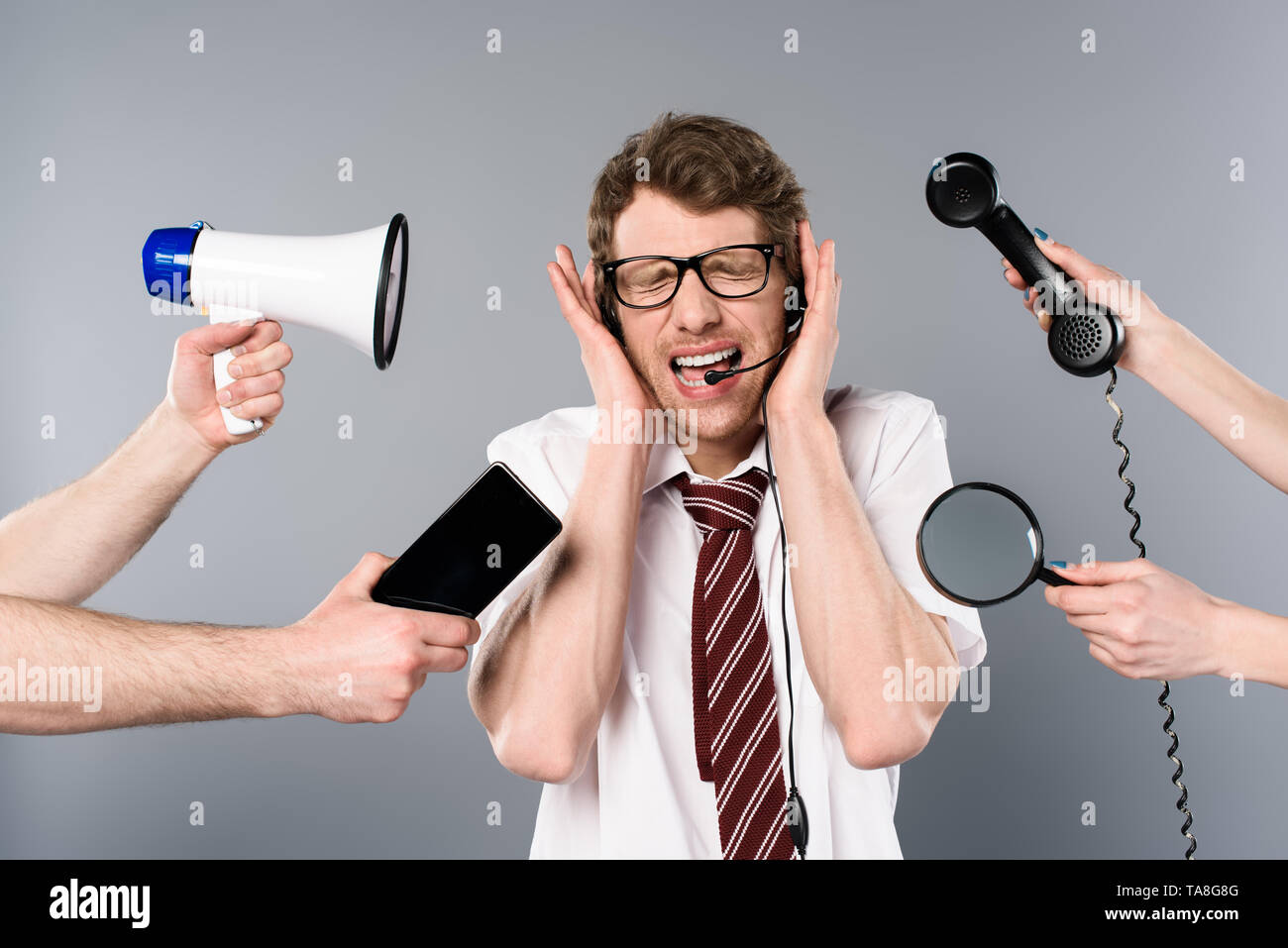 stressed call center operator in headset screaming near megaphone ...