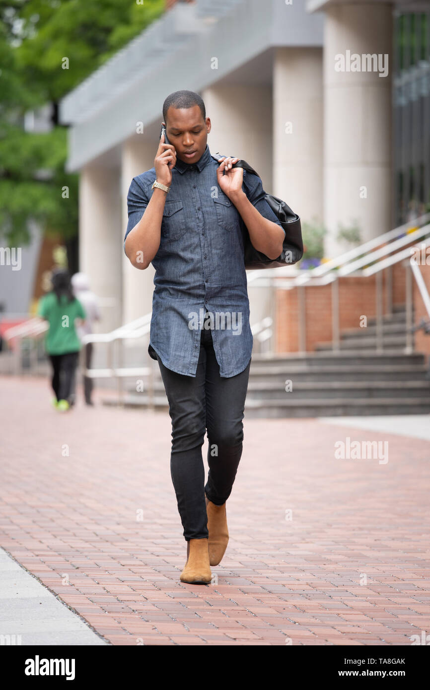 Young black man walking street alone hi-res stock photography and ...