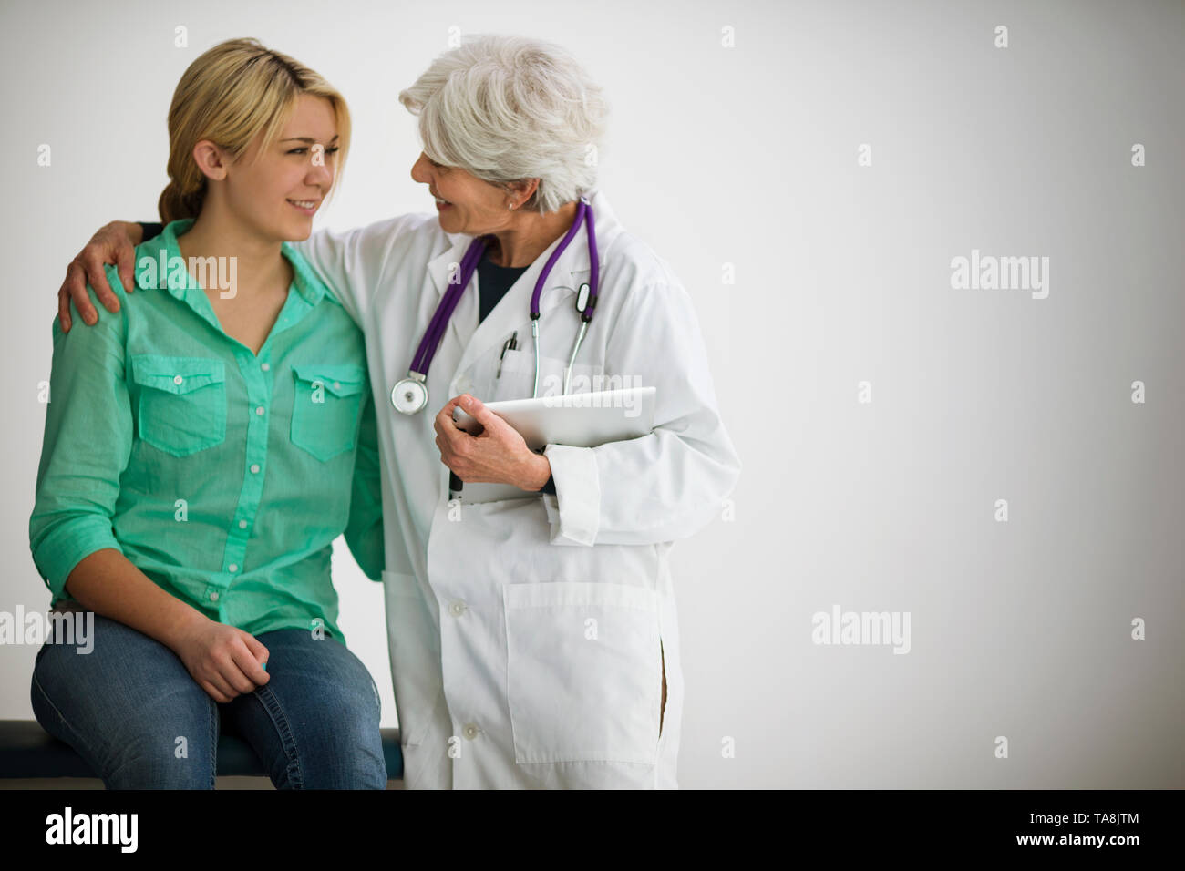 Young female doctor communicating patient hi-res stock photography and ...