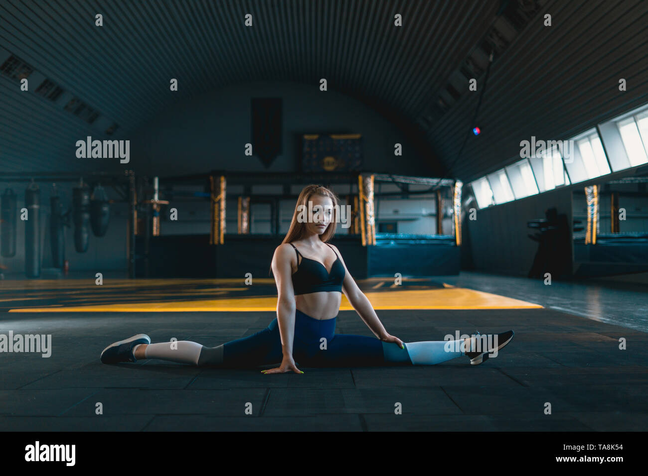 Stretching gymnast girl doing vertical split, twine. Side view of ...