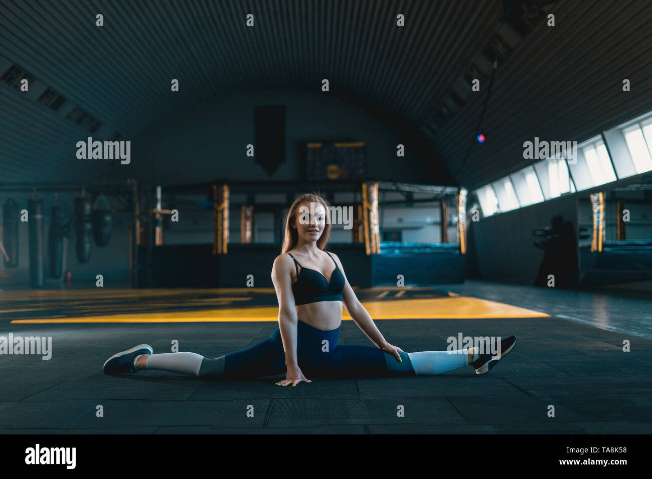 Stretching gymnast girl doing vertical split, twine. Side view of ...