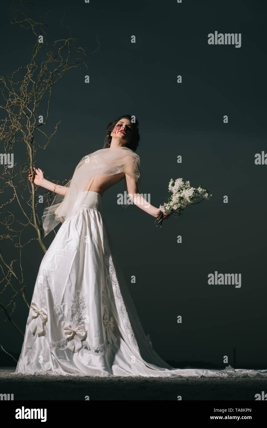 halloween wedding. woman in wedding dress with blood tears. happy ...