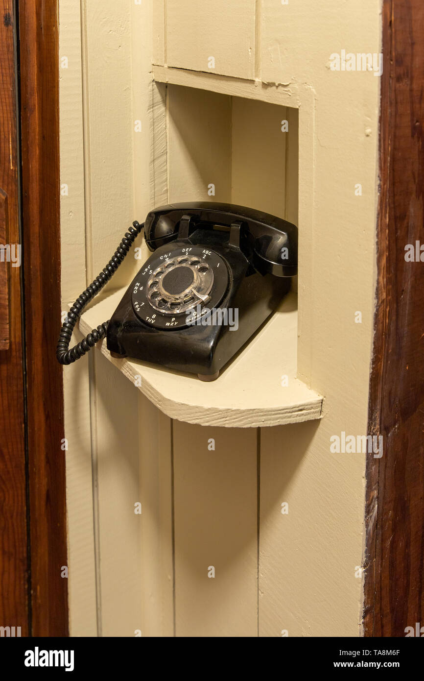 Old black rotary telephone in hallway phone nook Stock Photo - Alamy
