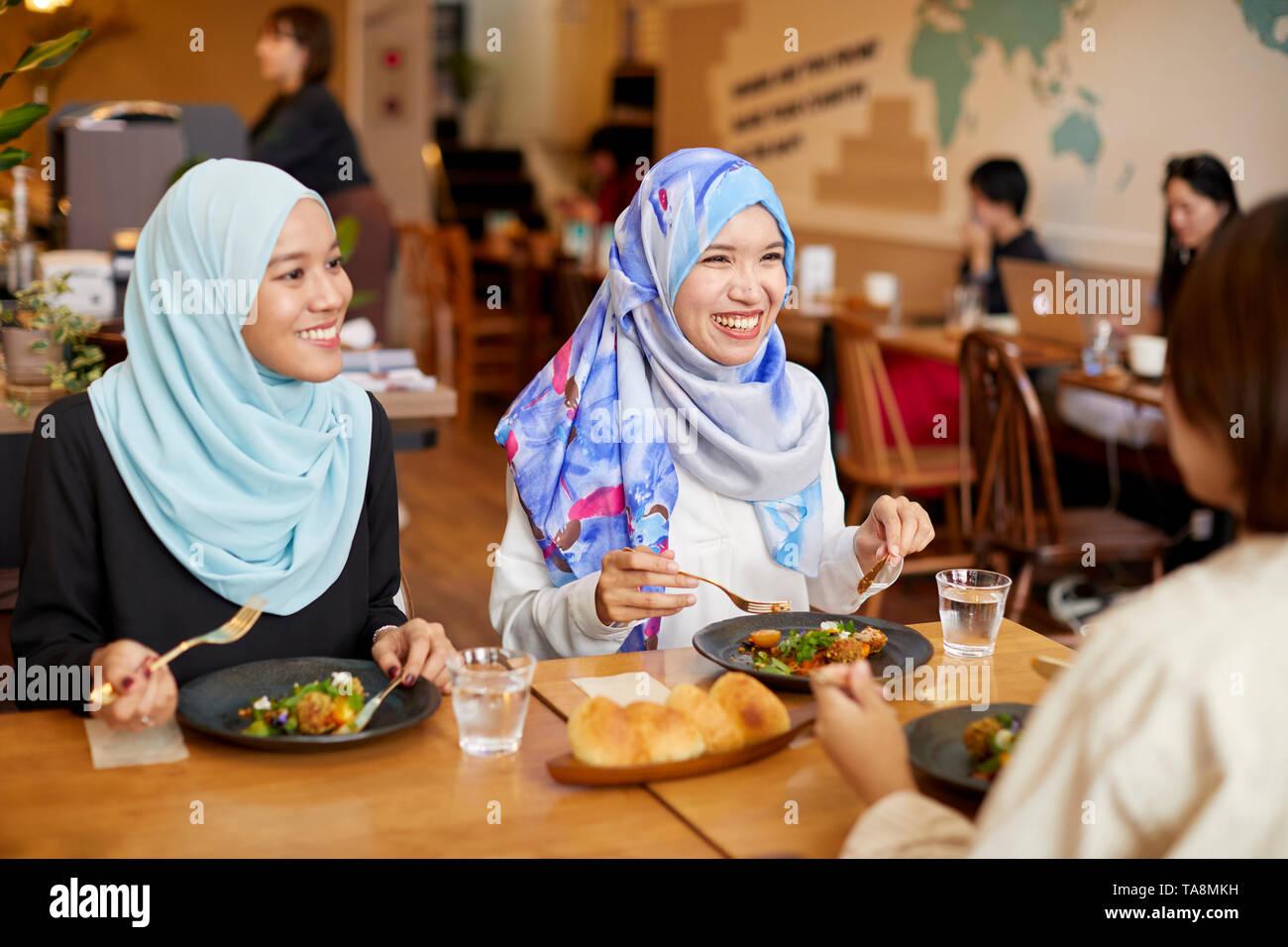 Young South-east Asian women eating at restaurant Stock Photo - Alamy