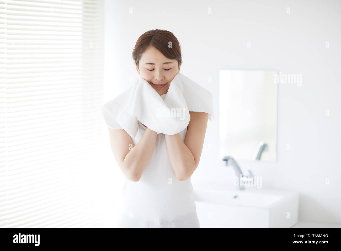 Young Japanese woman at home getting ready in the morning Stock Photo ...