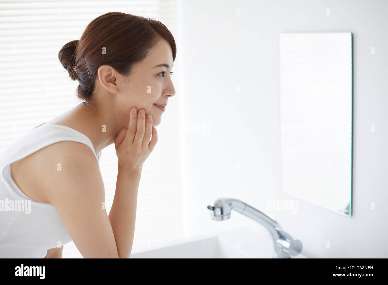 Young Japanese woman at home getting ready in the morning Stock Photo ...