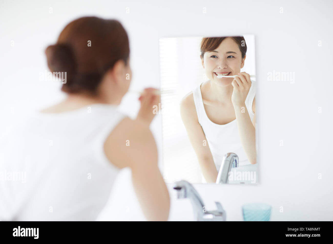 Young Japanese woman at home getting ready in the morning Stock Photo ...