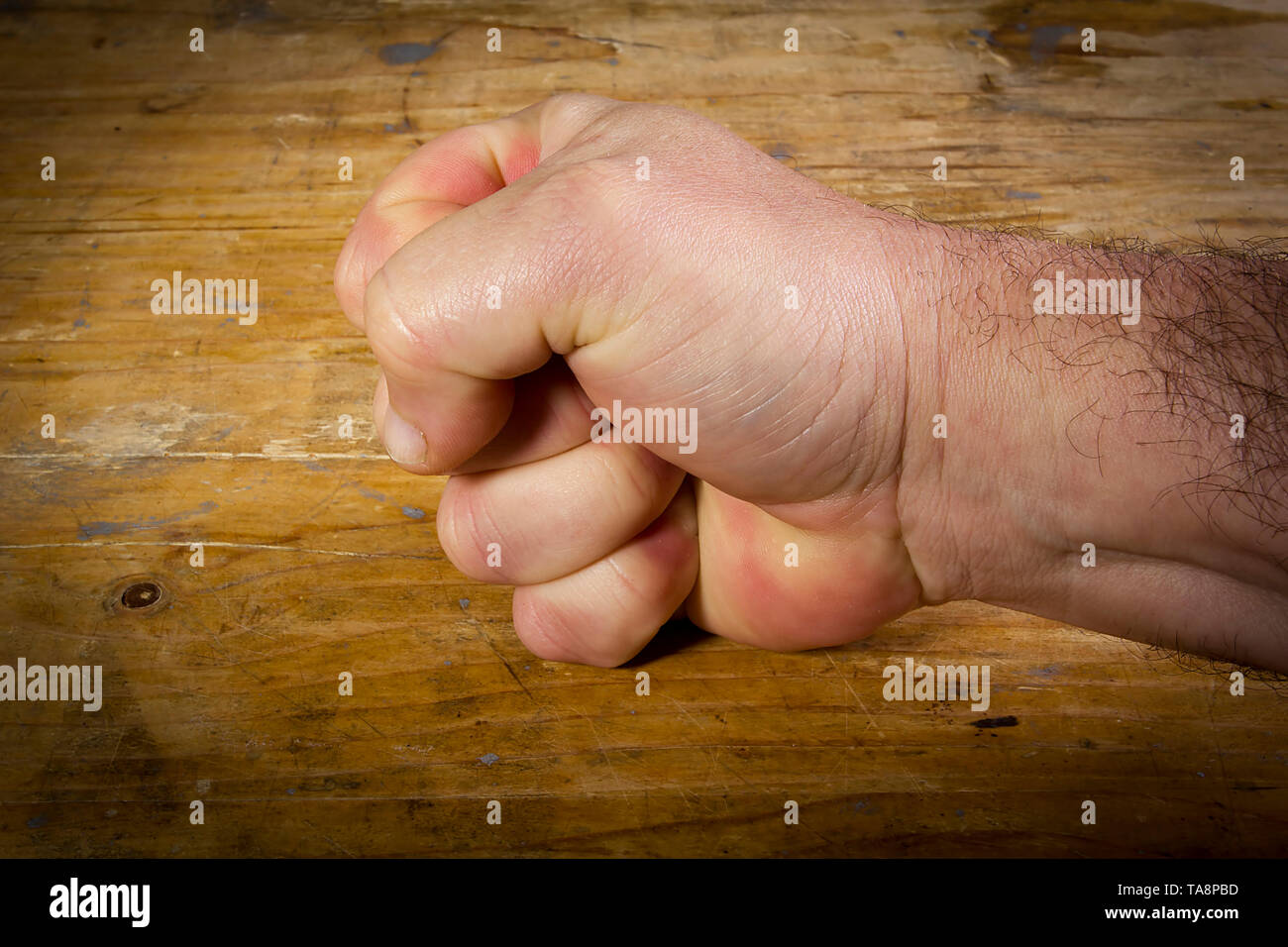 Clenched fist on table hi-res stock photography and images - Alamy
