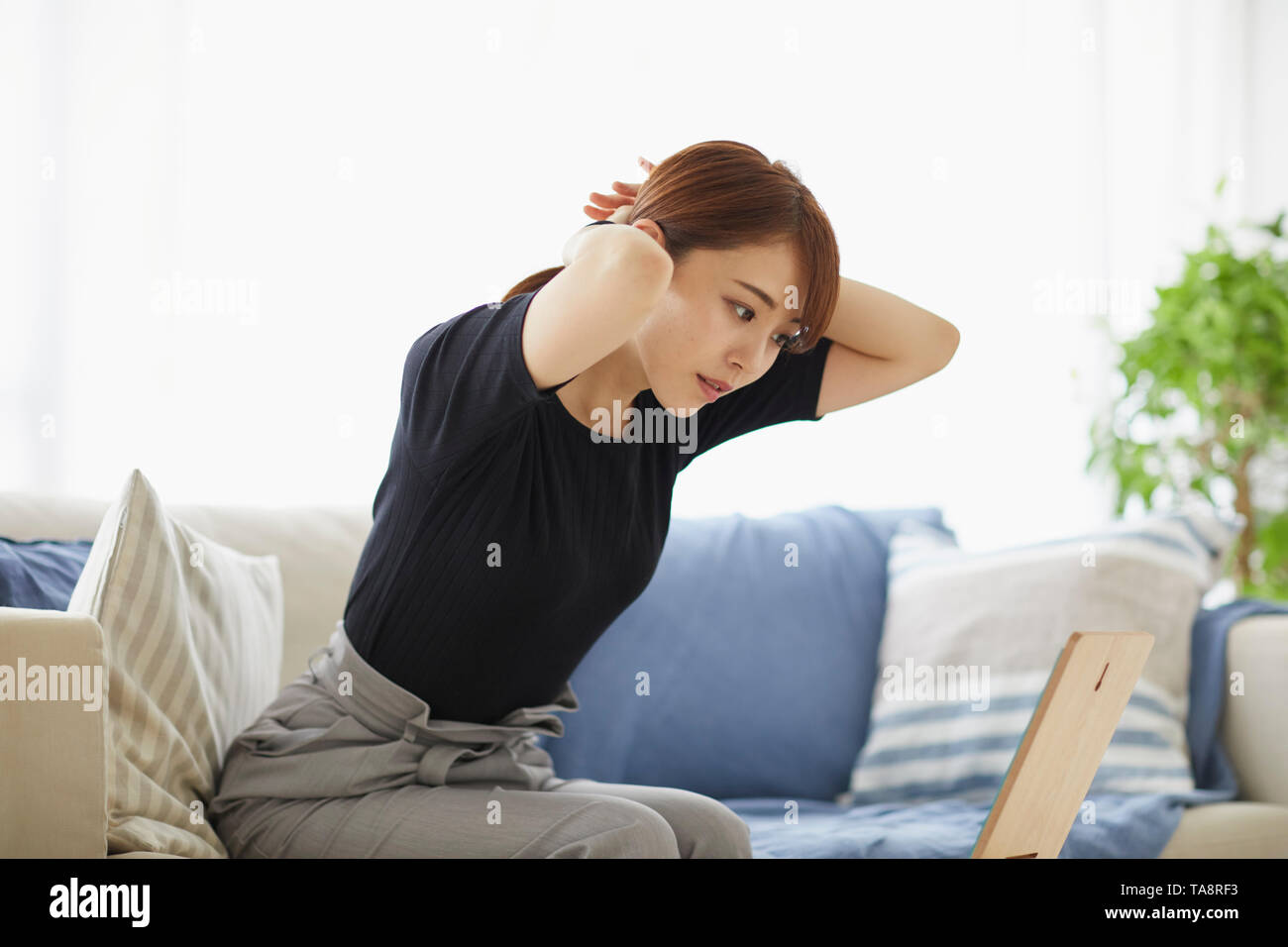 Young Japanese woman at home getting ready in the morning Stock Photo ...