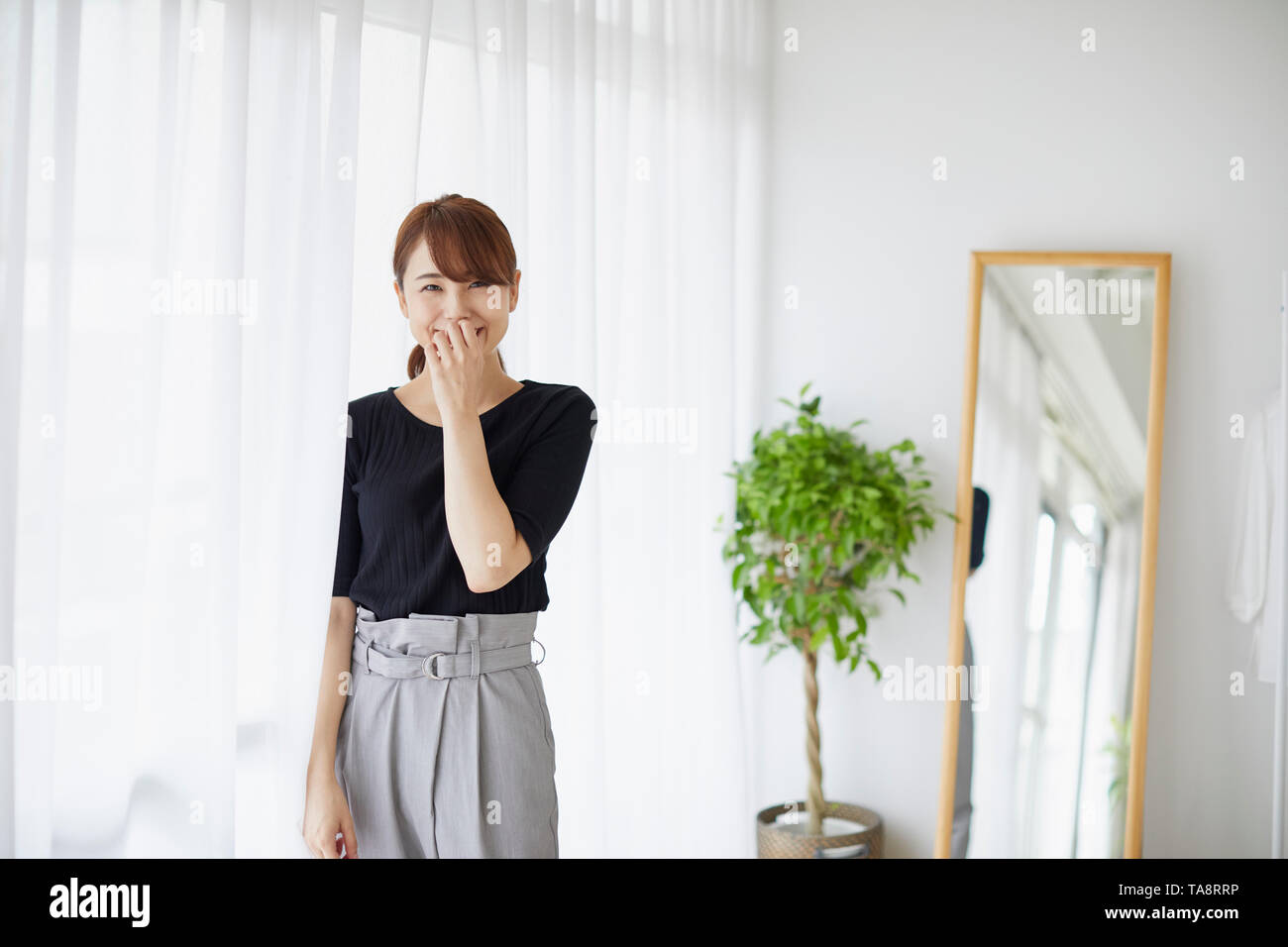 Young Japanese woman at home getting ready in the morning Stock Photo ...
