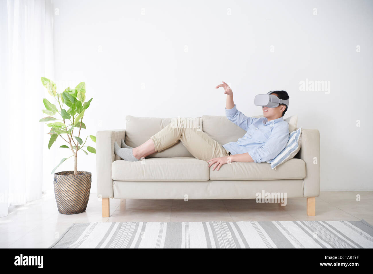Young Japanese man using VR goggles Stock Photo - Alamy