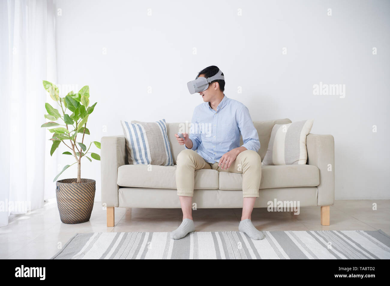 Young Japanese man using VR goggles Stock Photo - Alamy