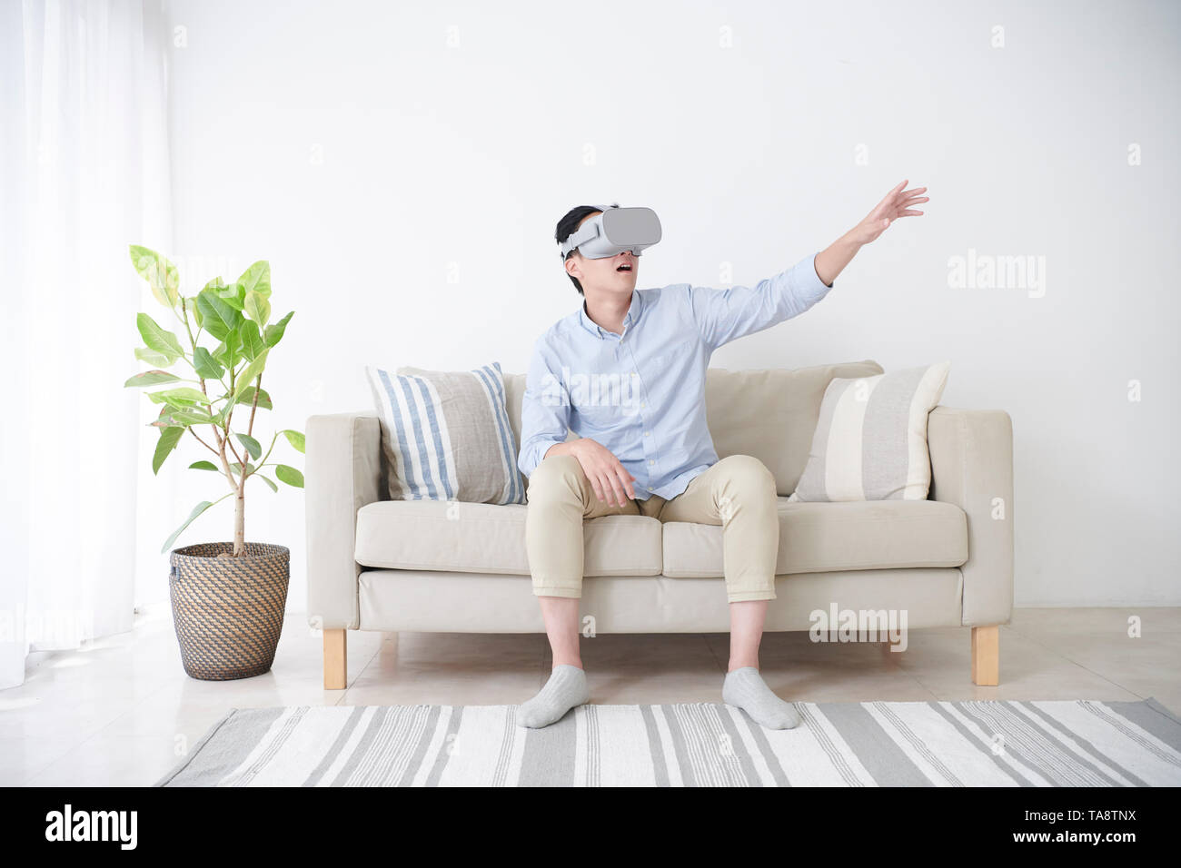 Young Japanese man using VR goggles Stock Photo - Alamy