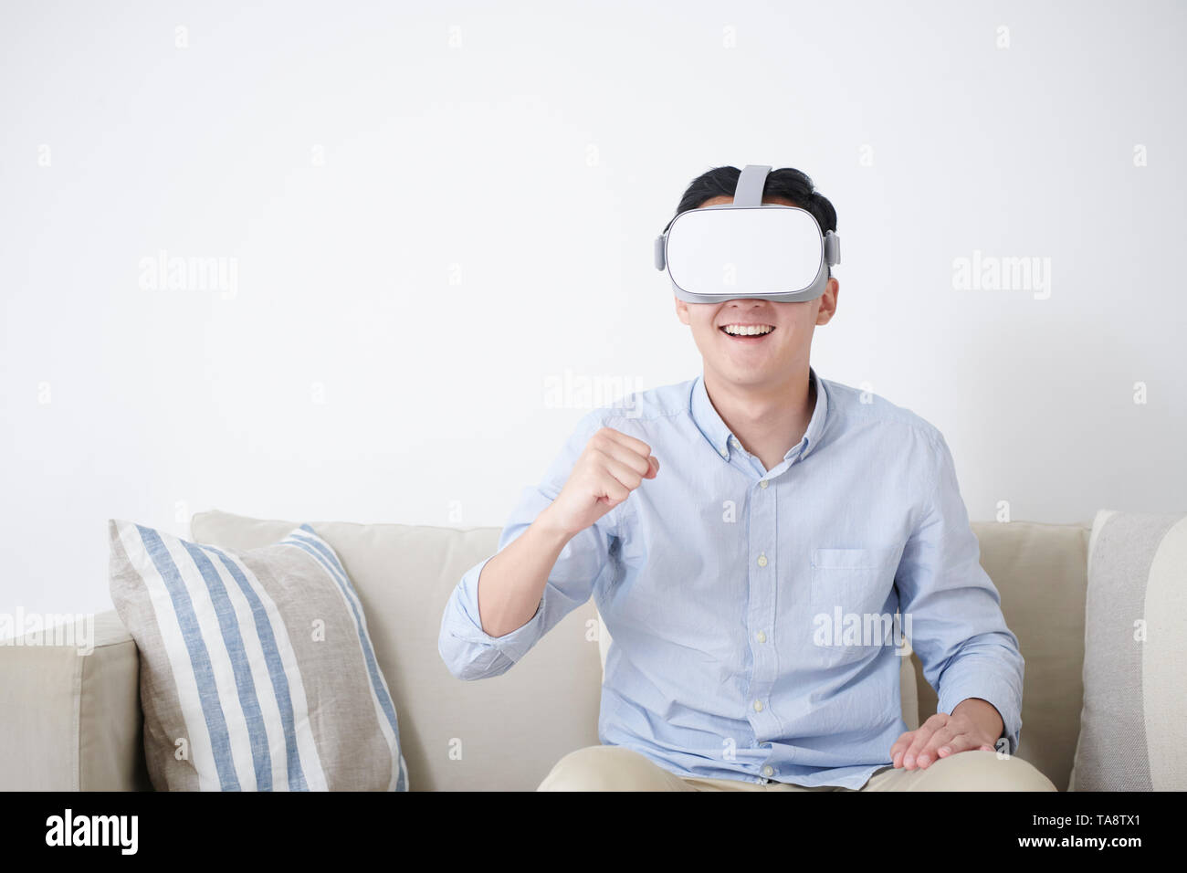 Young Japanese man using VR goggles Stock Photo - Alamy
