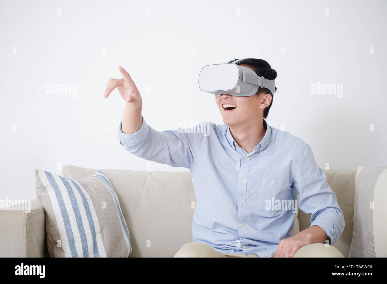 Young Japanese man using VR goggles Stock Photo - Alamy