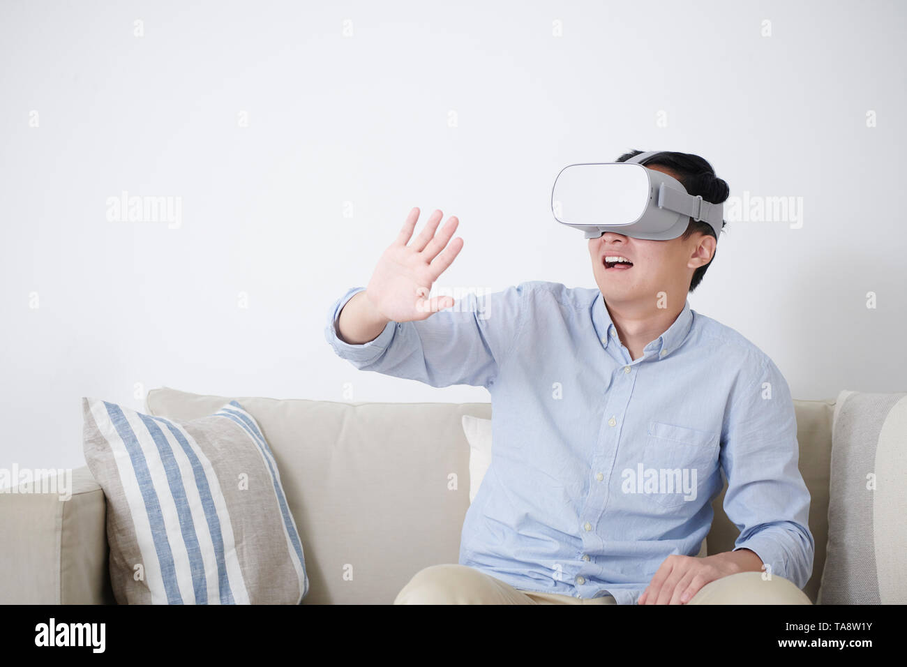 Young Japanese man using VR goggles Stock Photo - Alamy