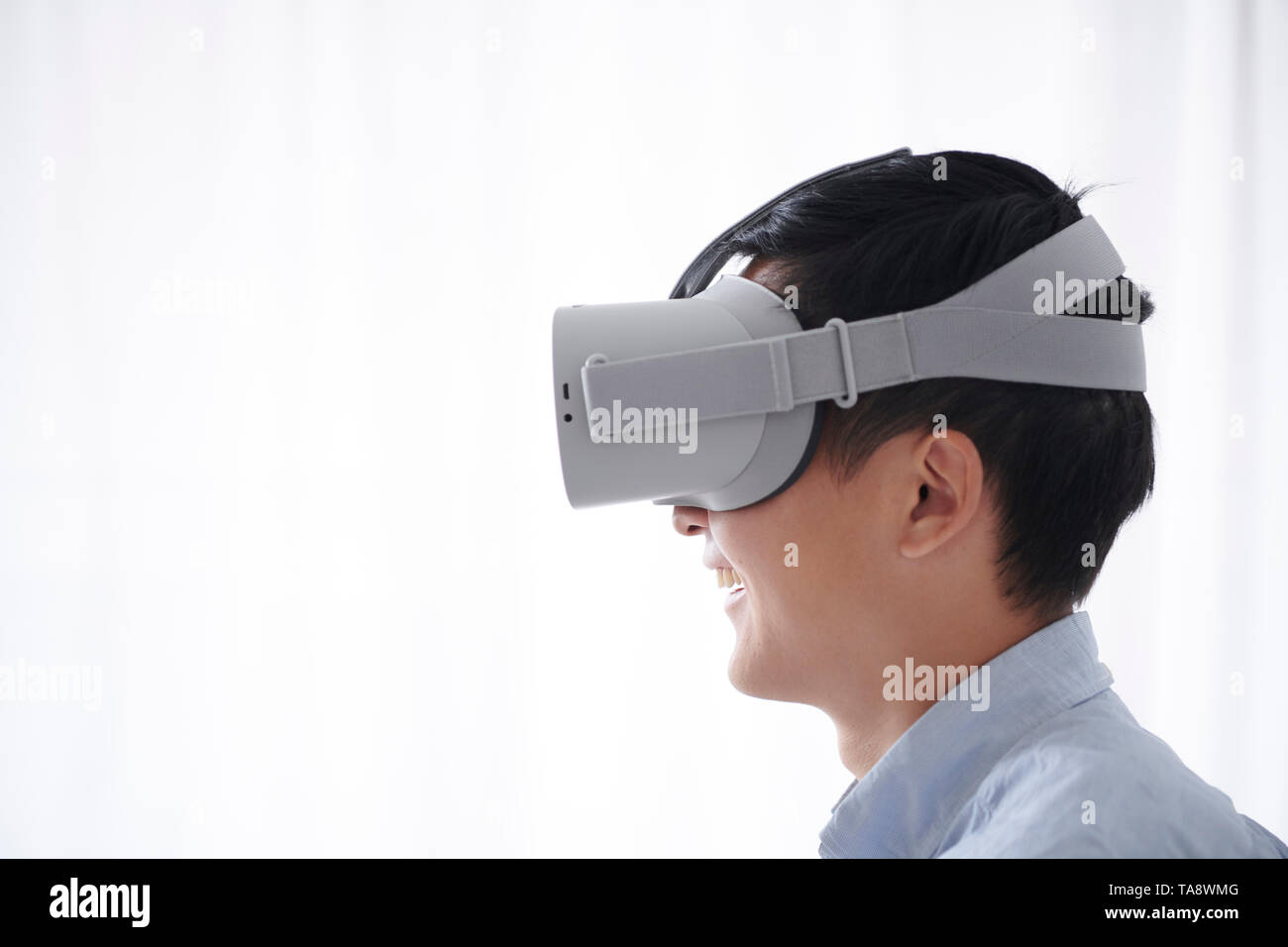 Young Japanese man using VR goggles Stock Photo - Alamy