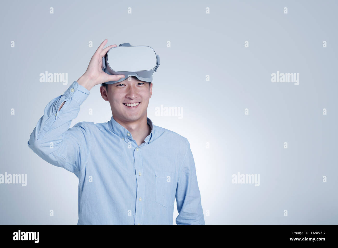 Young Japanese man using VR goggles Stock Photo - Alamy