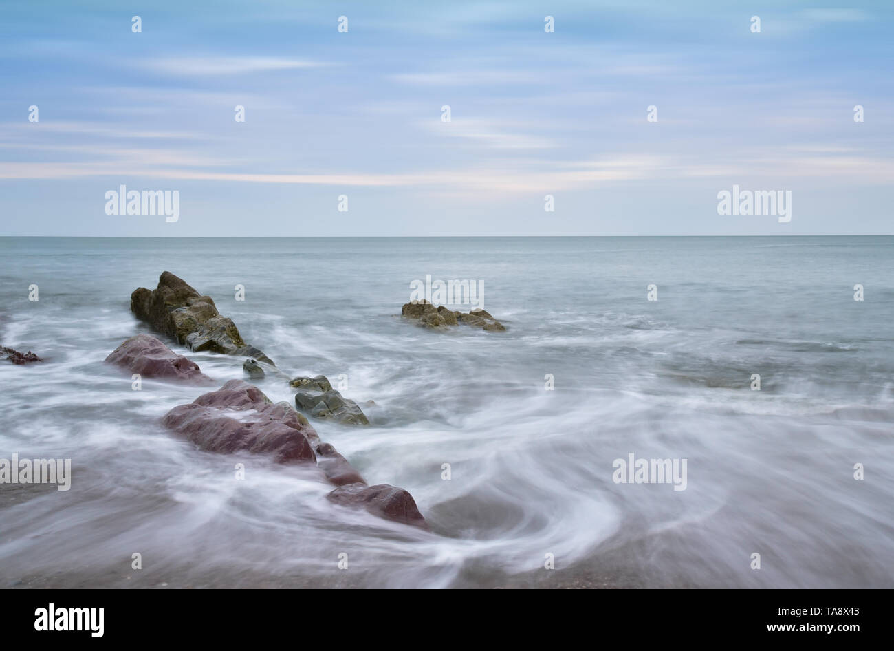 A very calm & clear sunset on Youghal strand Stock Photo - Alamy