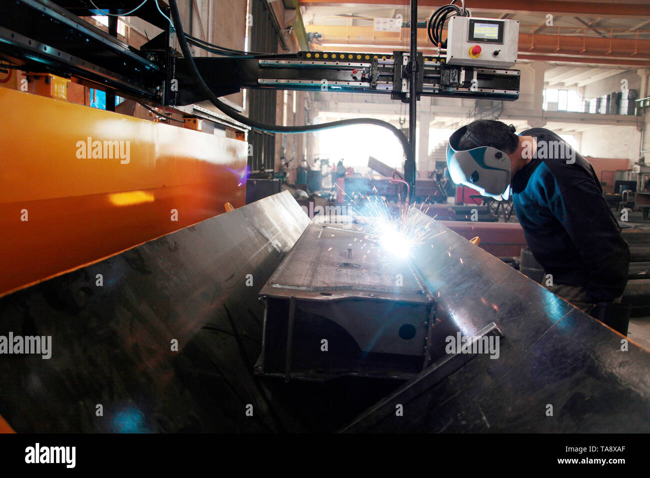 Worker and cnc machine Stock Photo - Alamy