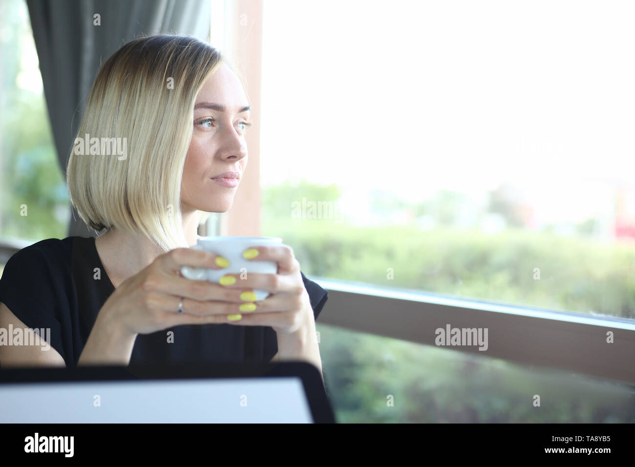 Gorgeous woman sitting in cafe Stock Photo - Alamy