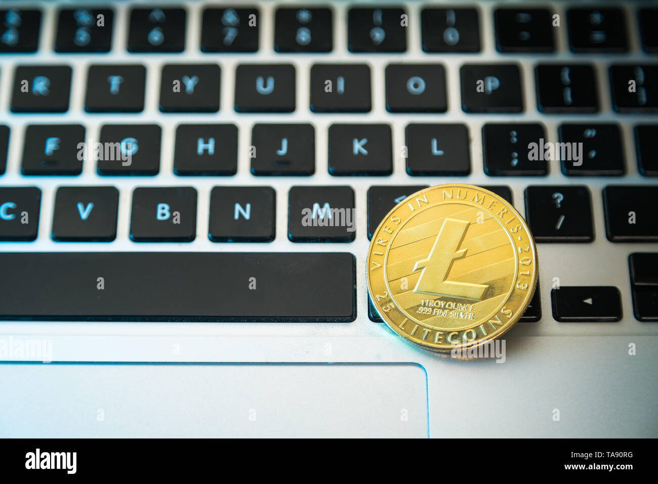Circle Litecoin, lite coin on top of computer keyboard buttons. Digital ...