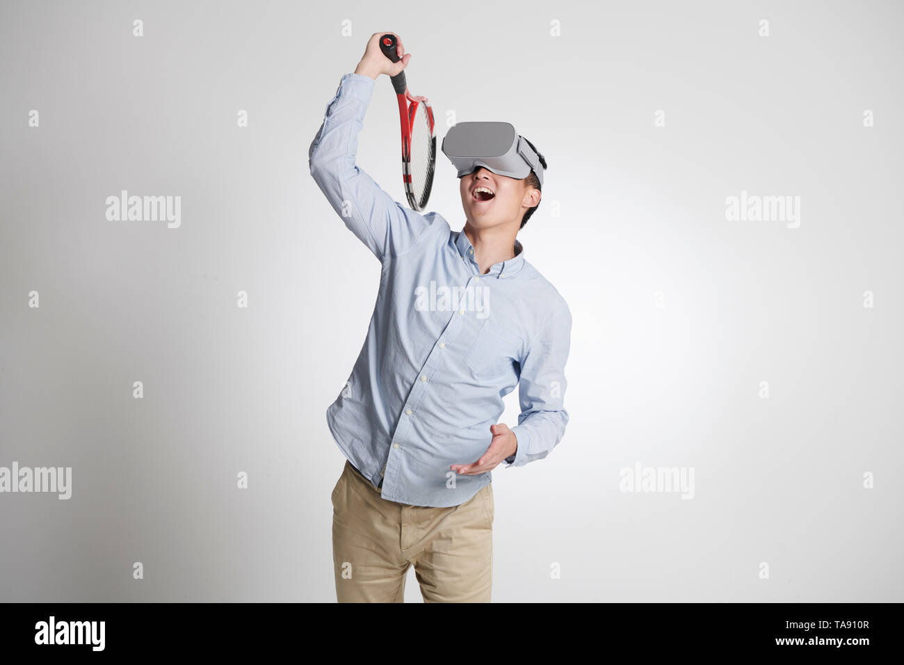 Young Japanese man using VR goggles Stock Photo - Alamy