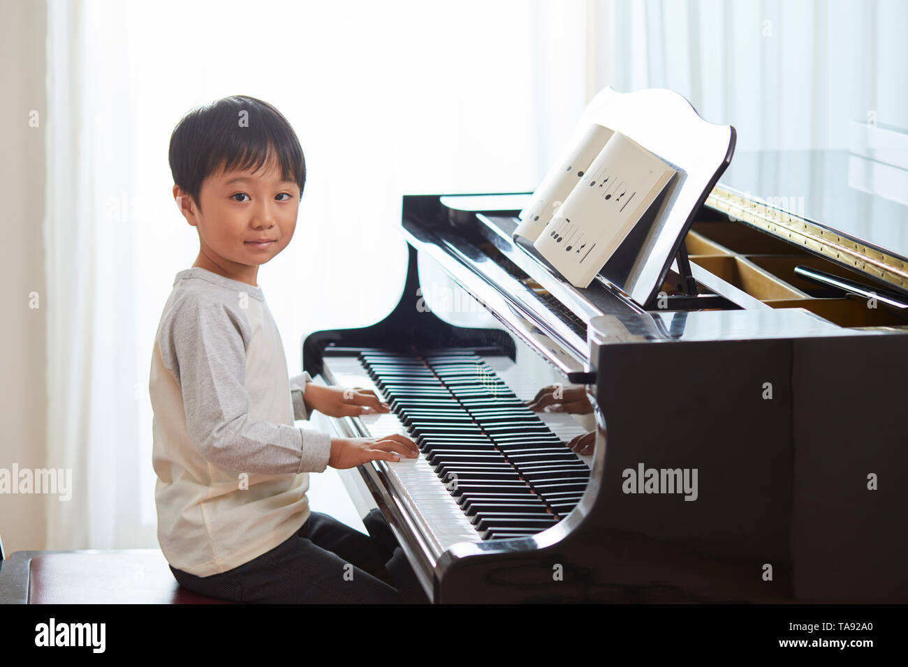 Japanese kid practicing piano Stock Photo - Alamy
