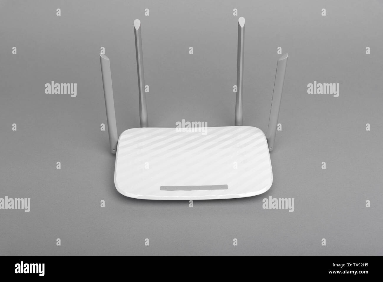 White modern Wi-Fi router with four antennas on gray background Stock ...