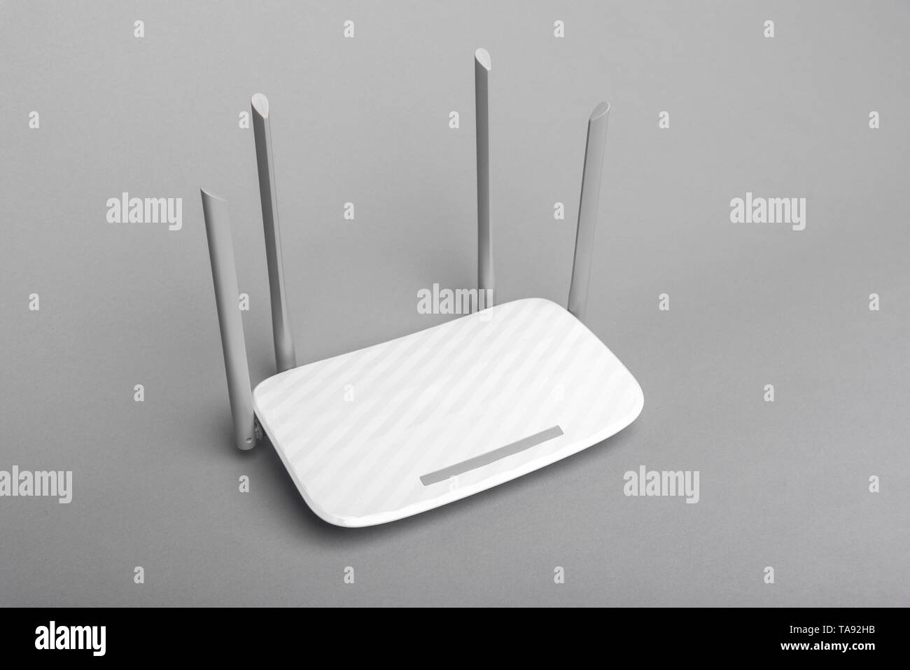 White modern Wi-Fi router with four antennas on gray background Stock ...