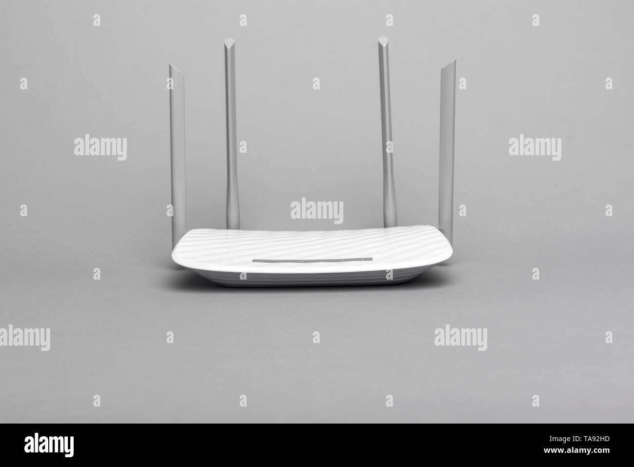 White modern Wi-Fi router with four antennas on gray background Stock ...