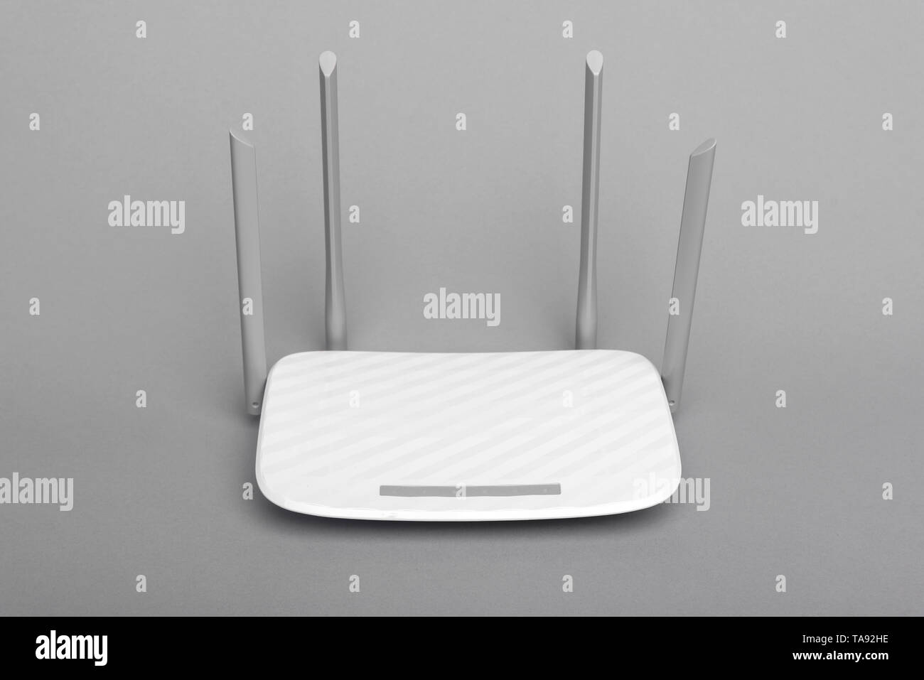 White modern Wi-Fi router with four antennas on gray background Stock ...