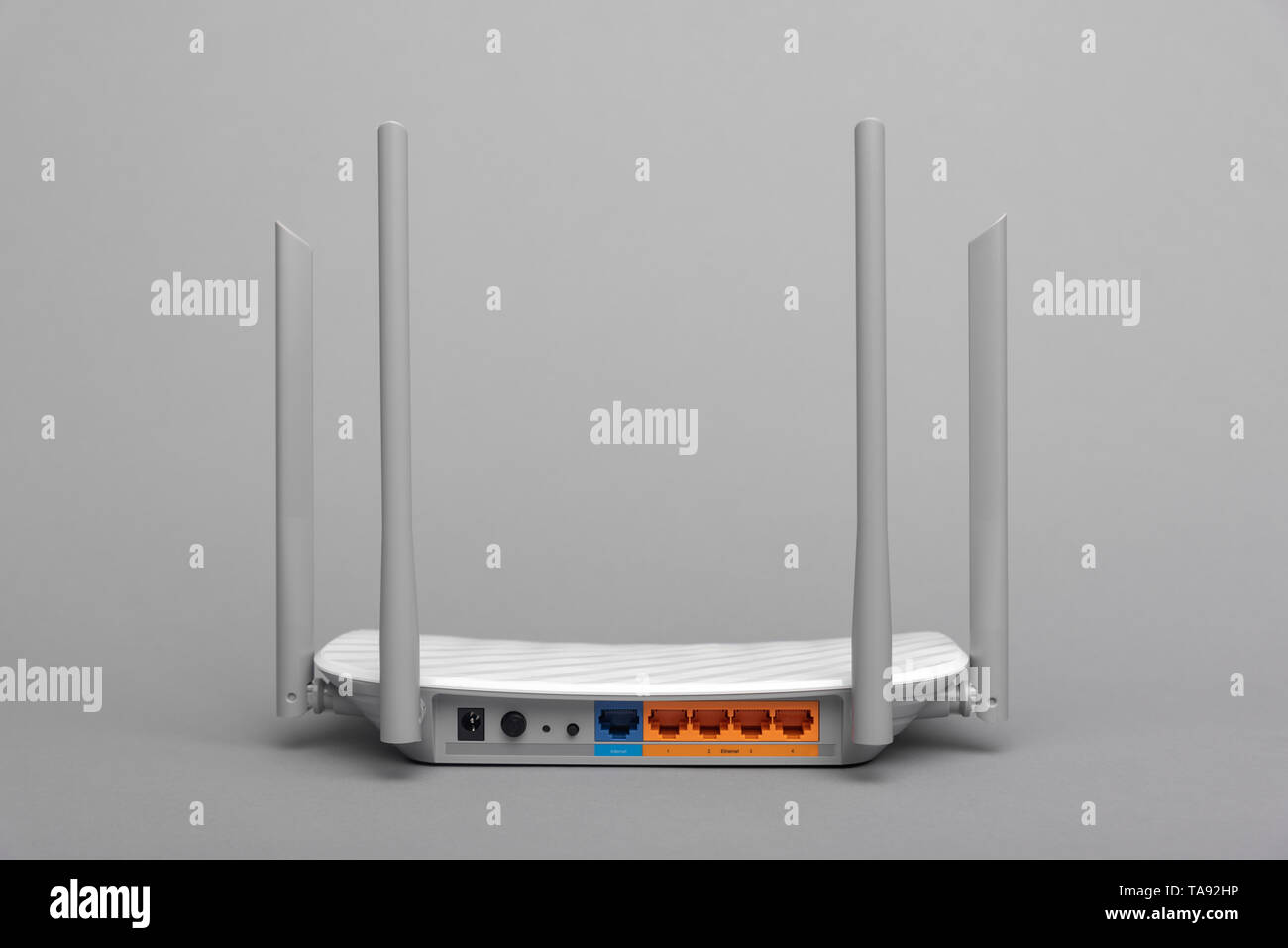 White modern Wi-Fi router with four antennas on gray background Stock ...