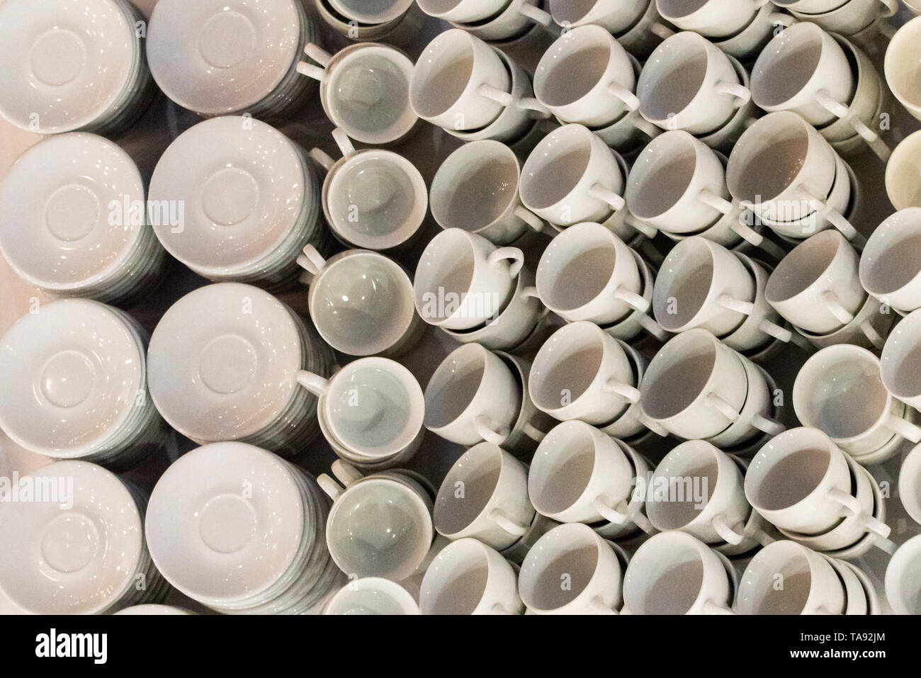 White coffee cups in rows on table. Cup prepared for hot drink such as ...