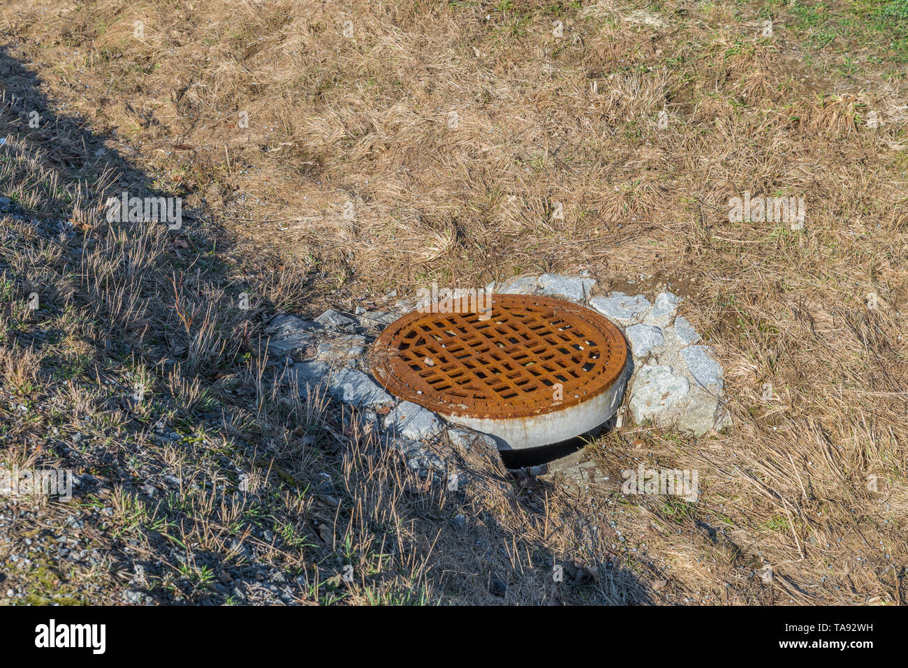 Rusty iron manhole cover in a ditch, Germany Stock Photo - Alamy