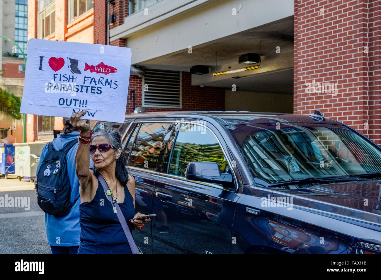 Woman protesting Fish farms with I love salmon sign Stock Photo - Alamy