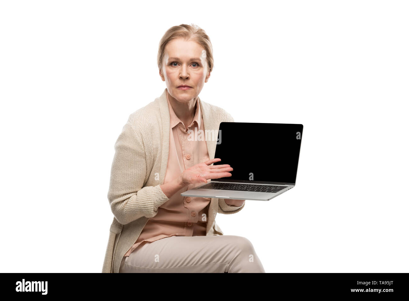 confused middle aged woman holding laptop with blank screen and ...