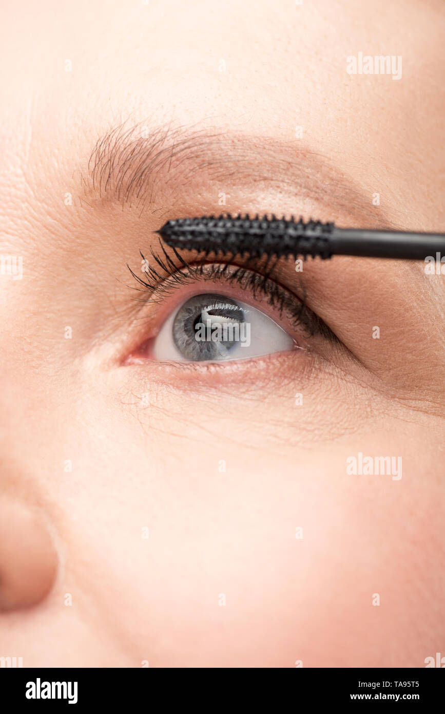close up of mature woman applying mascara Isolated On White Stock Photo ...
