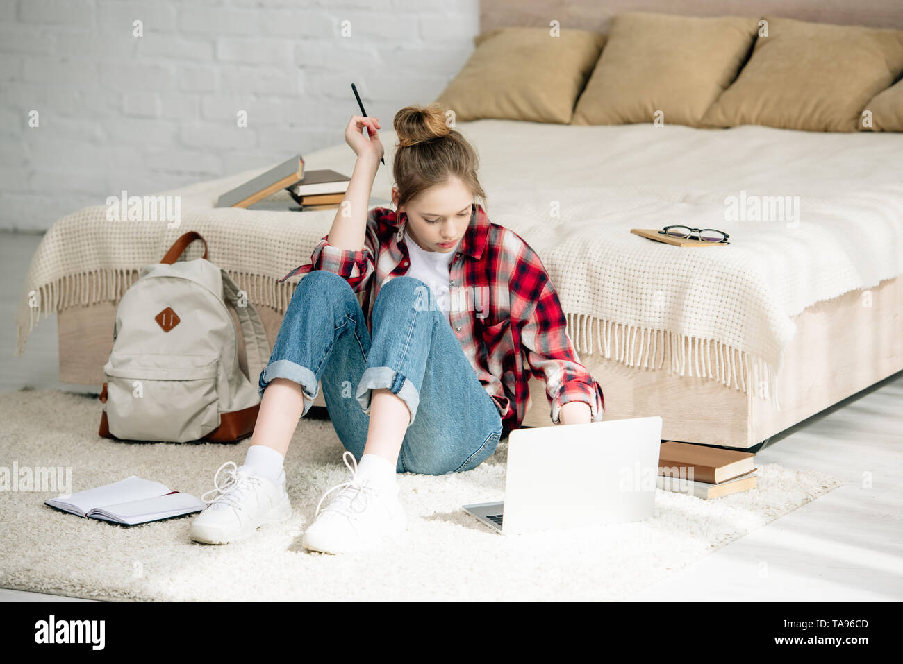 Teen girl doing homework sitting hi-res stock photography and images ...
