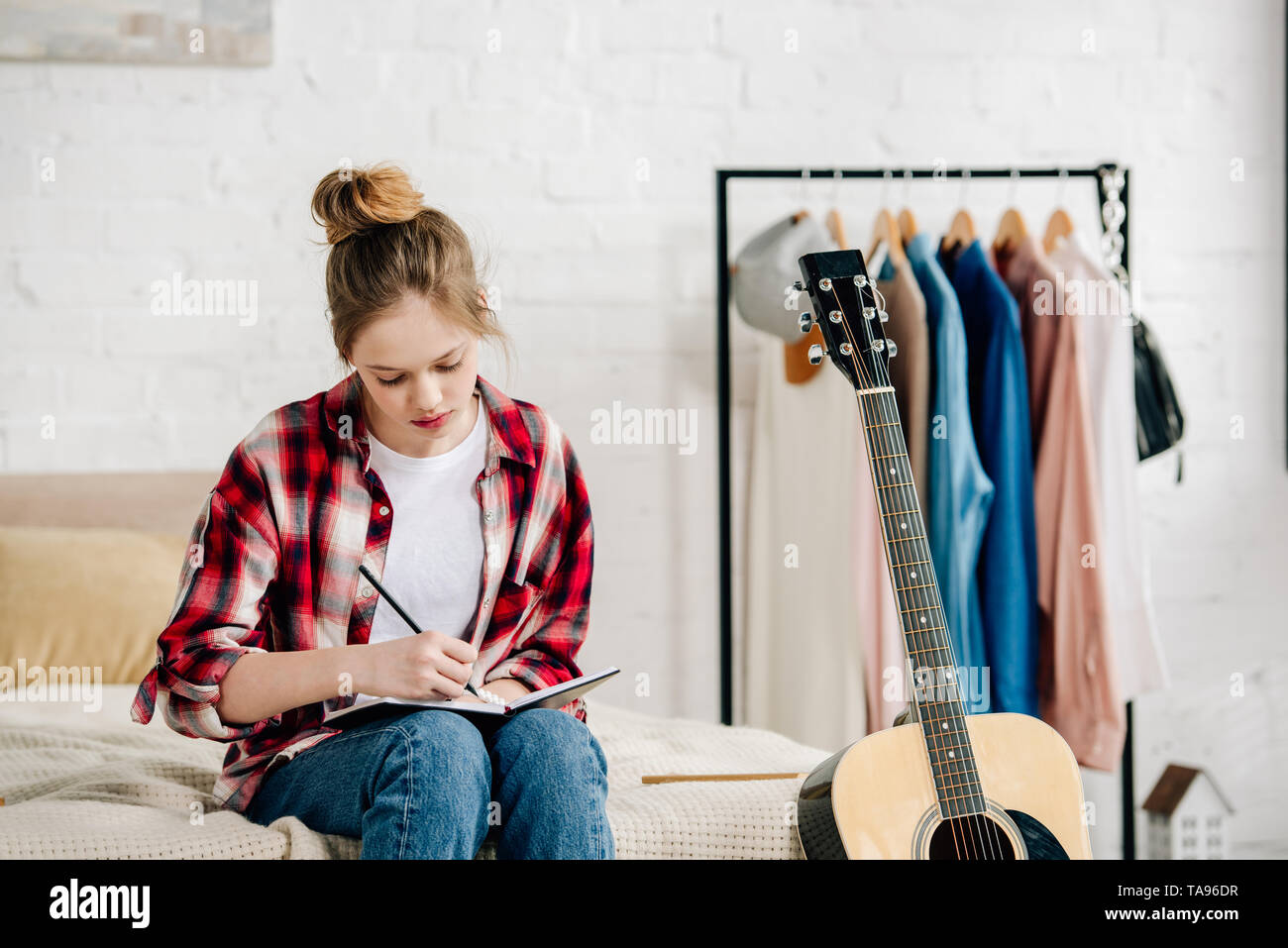 Teenager doing homework on bed hi-res stock photography and images - Alamy