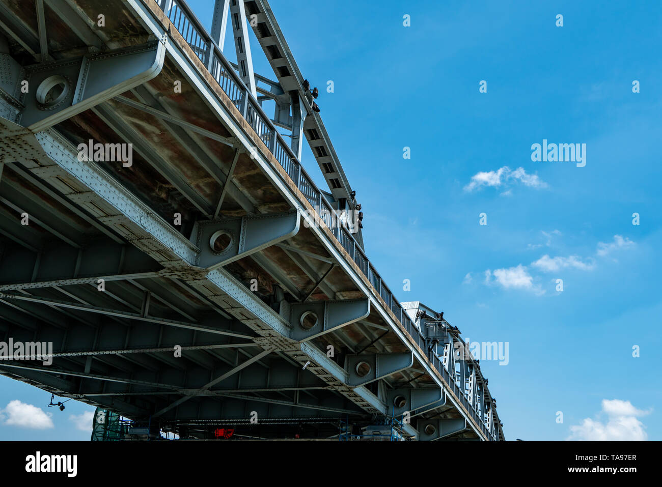 Steel bridge structure against blue sky and white clouds. Iron bridge ...