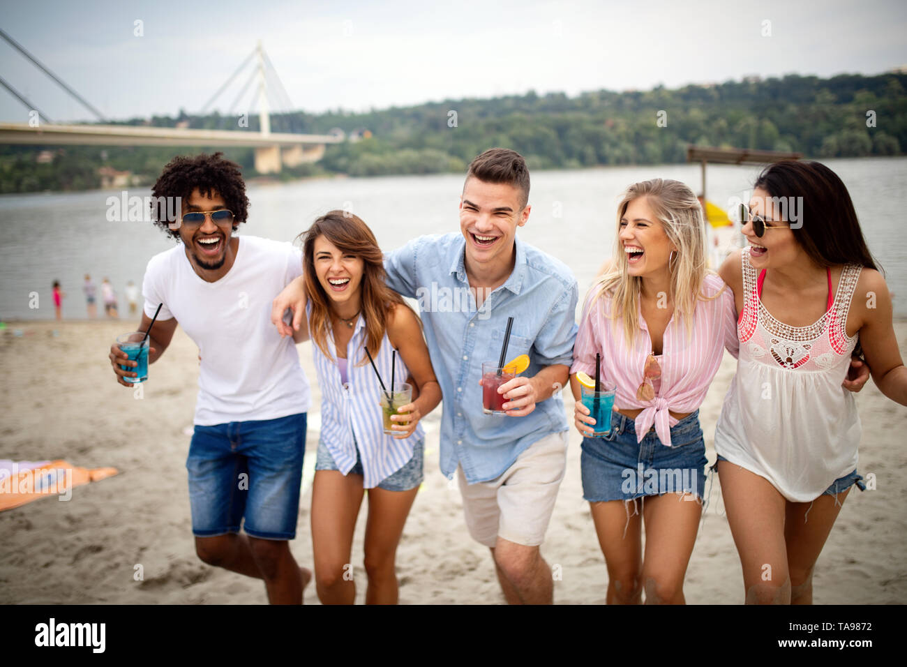 A group of men and women on the beach hi-res stock photography and ...